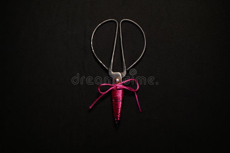 Vintage Scissors Wrapped with Bright Pink Thread on a Dark Background ...