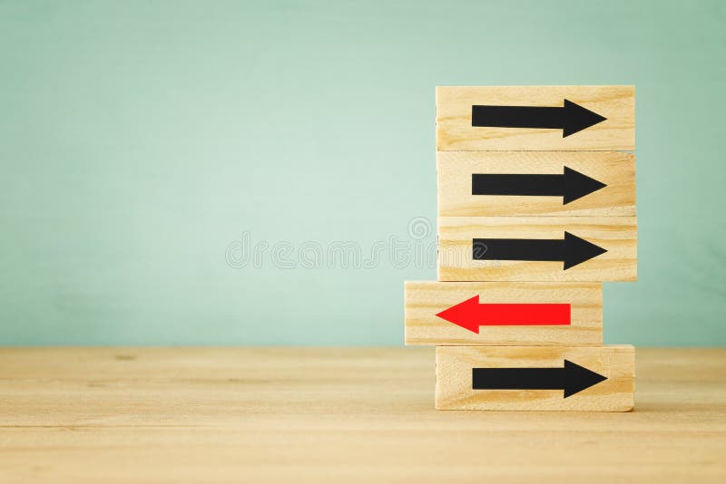 Unique Red Arrow Brick among Many Black Ones. Standing Out from Crowd ...