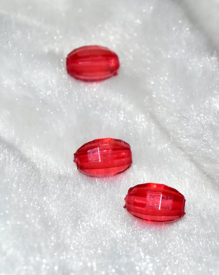Red Objects on Top of a Soft White Cloth Background Photograph Stock ...