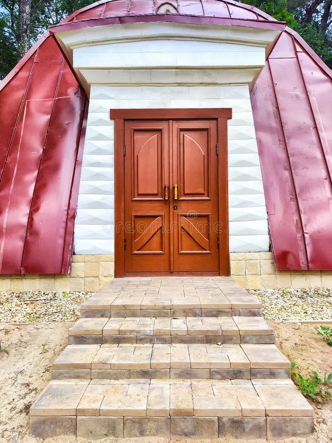 A Unique Red-roofed Structure Surrounded by Trees in a Serene Forest ...