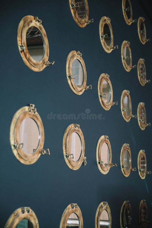 Unique Wall Design Featuring Multiple Round Mirrors Arranged in a ...