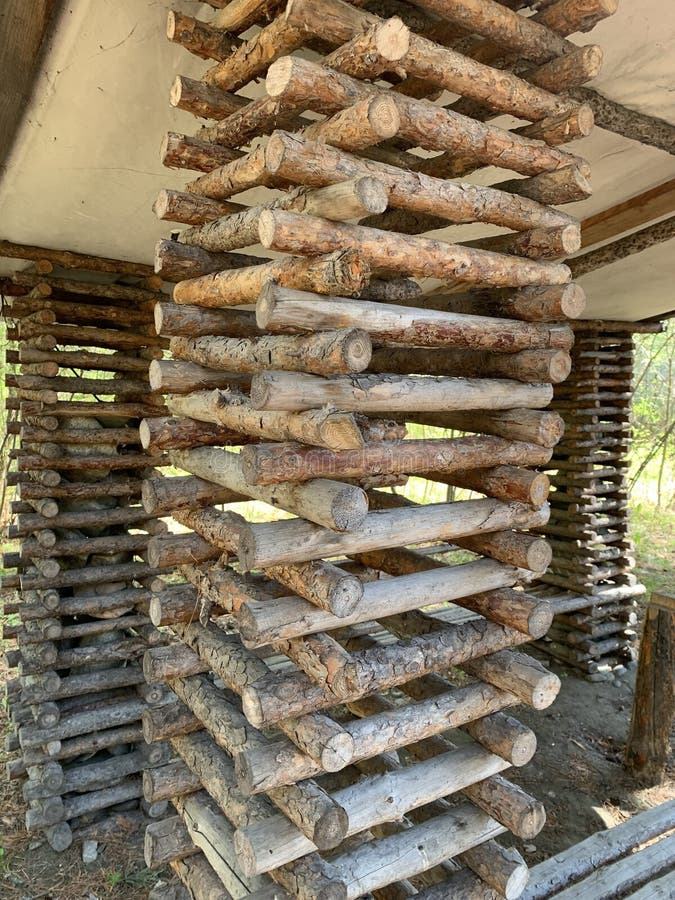 Unique Wooden Log Structure Resembling a Tower with Square Base and ...
