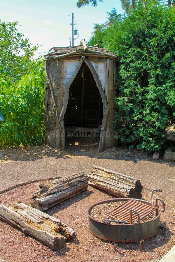Unique Wooden Shelter with Fire Pit in Green Landscape Stock Photo ...