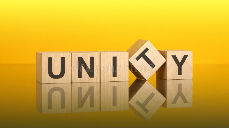 UNITY - Text of on Wooden Cubes, Reflected from the Bright Yellow ...