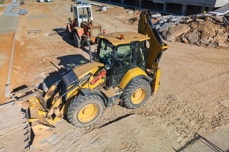 Universal Excavator or Loader with Folded Bucket at Construction Site ...