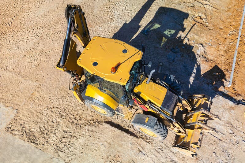 Universal Excavator or Loader with Folded Bucket at Construction Site ...