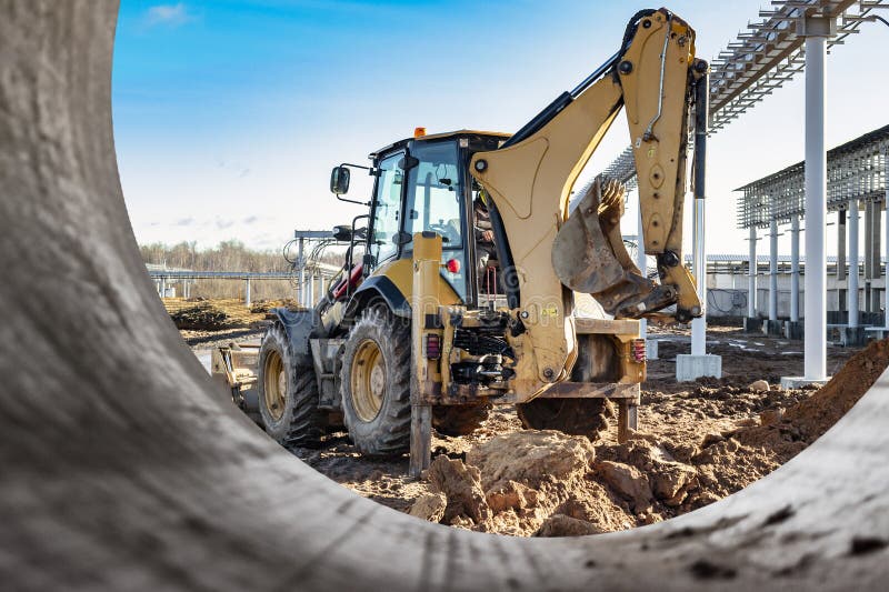 A Universal Excavator or Loader is Working on a Construction Site ...