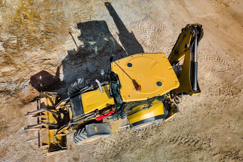 A Universal Excavator or Loader is Working on a Construction Site ...