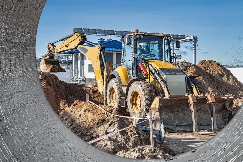A Universal Excavator is Working on a Construction Site Against a ...