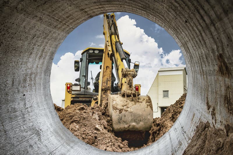 A Universal Excavator is Working on a Construction Site Against a ...