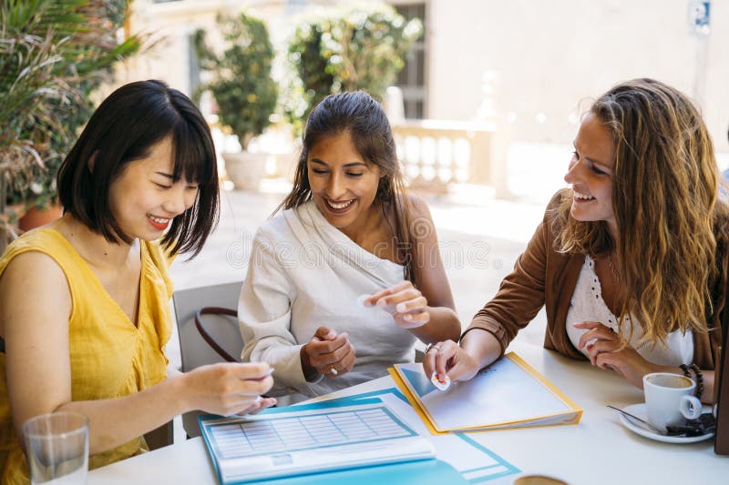 University Exchange Students Organizing Notes at a Cafe Stock Image ...