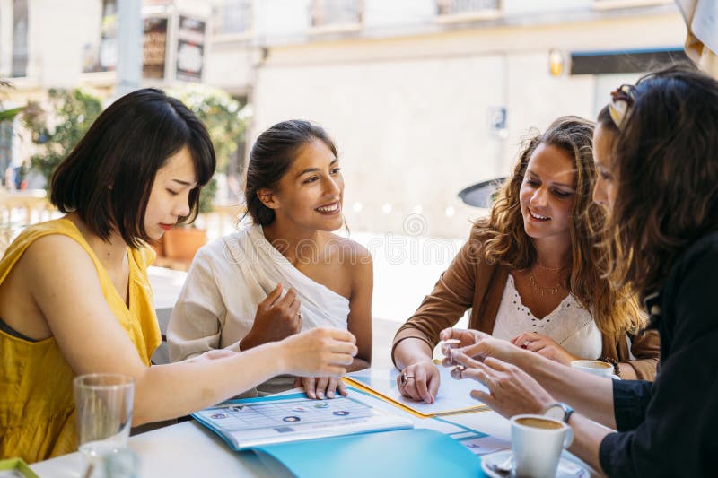 University Exchange Students Working Together at a Cafe Stock Photo ...