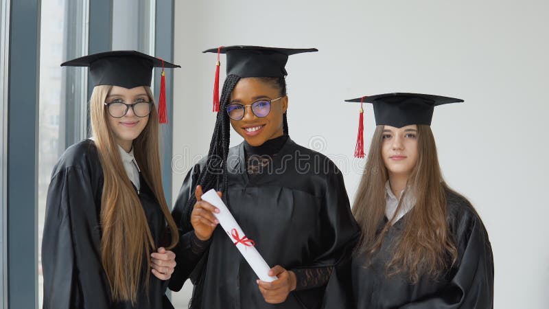 Three Female Students of Different Races with a Diploma in Hand. Higher ...