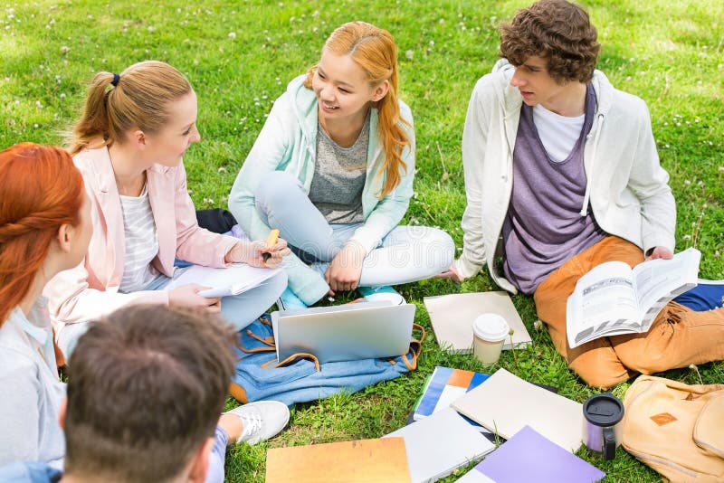 University Friends Studying Together on Grass Stock Photo - Image of ...