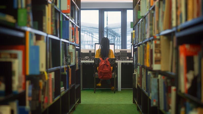 University Library: Focused Bright Student Working on Personal Computer ...