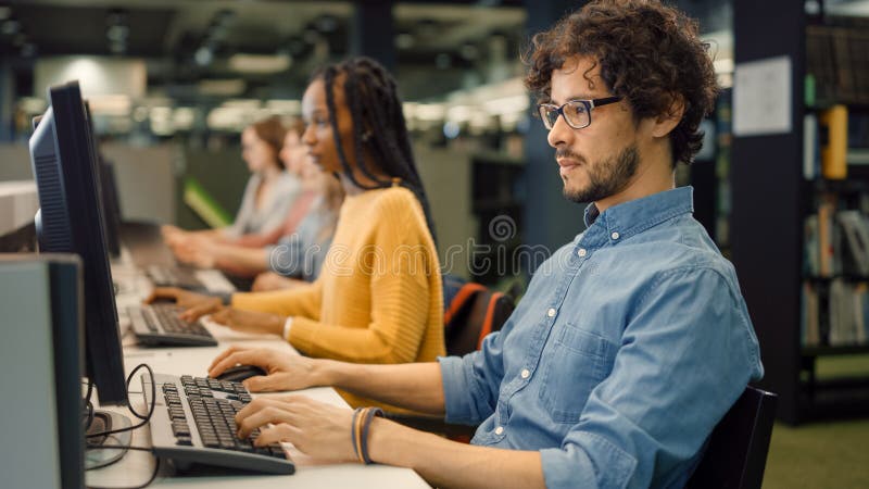 University Library: Handsome Bright Boy Using Computer for Class ...