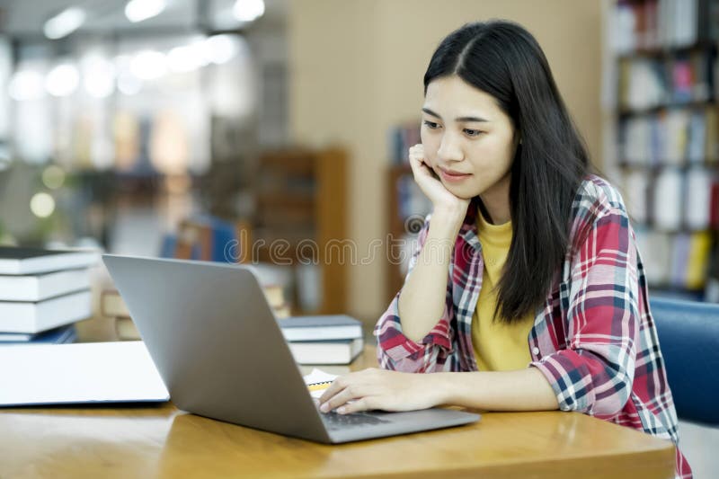 Young University Student Using Laptop for Online Learning, Searching ...