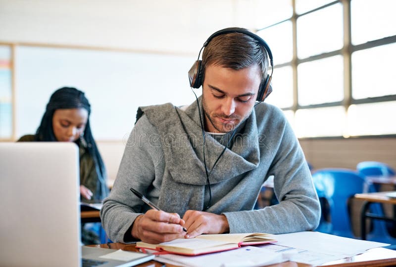 University, Man or Writing with Headphones in Classroom for Tutorial ...