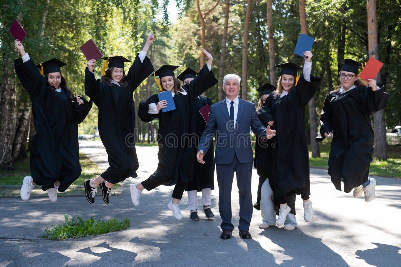 A University Professor and Seven Robed Graduates are Jumping Outdoors ...