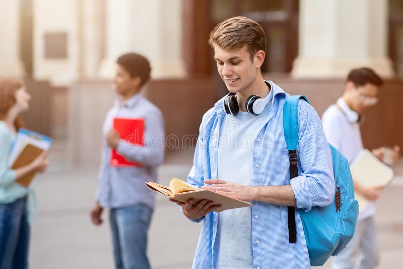 University Student Guy Reading Book Learning Standing Outside College ...