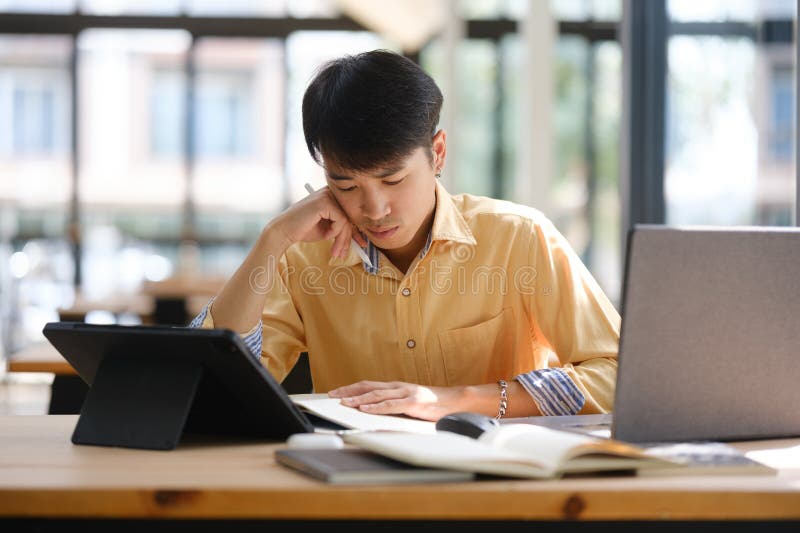 University Student Reviewing Notes and Preparing for an Important Exam ...