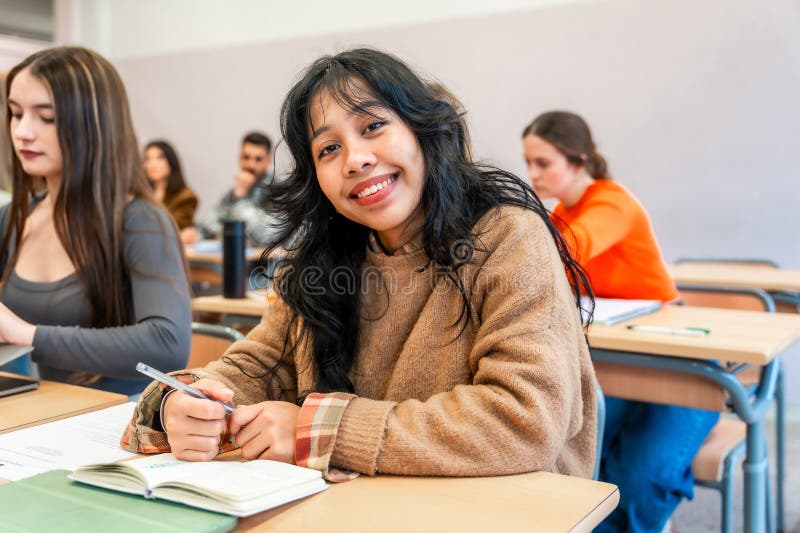 University Student Smiling and Taking Notes in Classroom Stock Image ...
