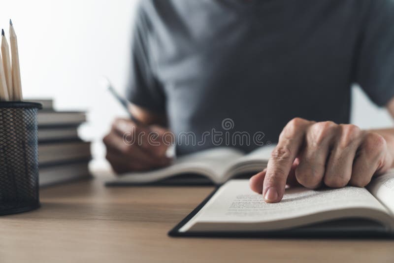 University Student Studying or Learning Book, Writing or Reading ...