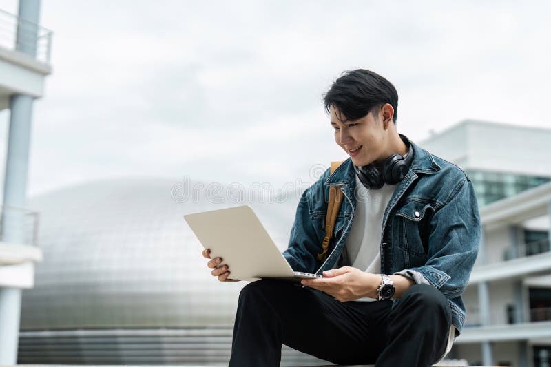 University Student Studying Outdoors with Laptop on Campus, Modern ...