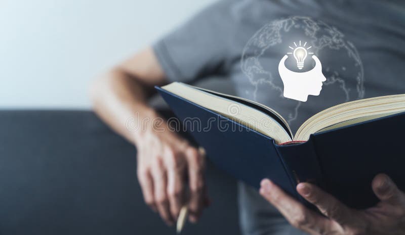 University Student Studying, Writing and Reading Book or Textbook with ...