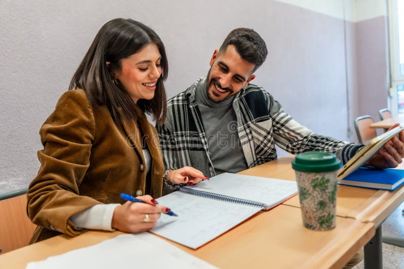 University Students Collaborating and Learning Together in Classroom ...