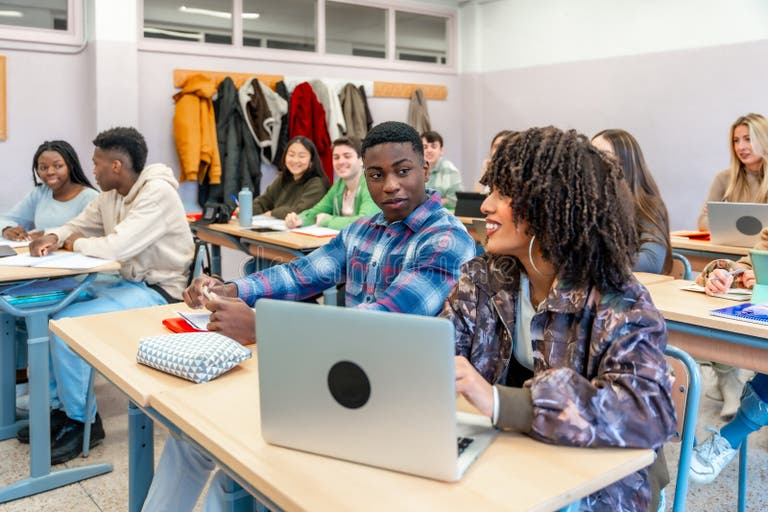 University Students Collaborating on Project with Laptop in Classroom ...