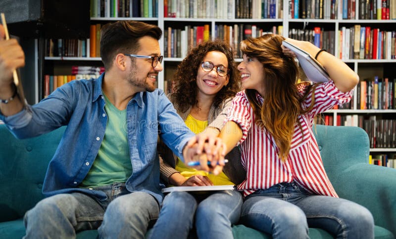 University Students in Cooperation at Library. Group of Young Friends ...