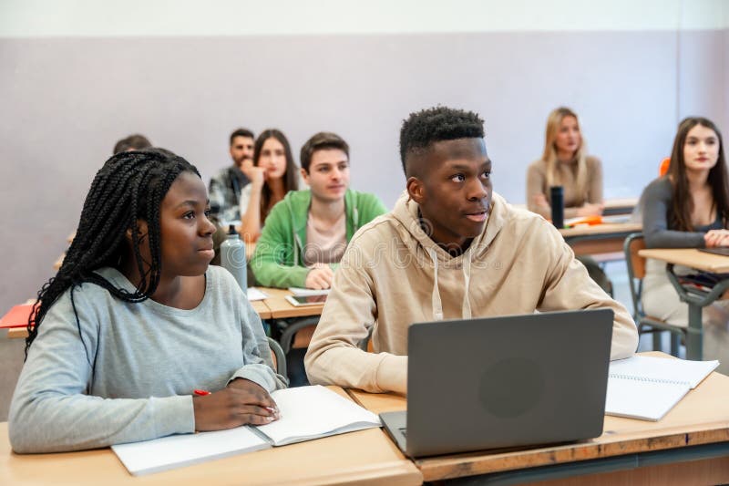 University Students Learning in Classroom Using Laptop and Notebook ...