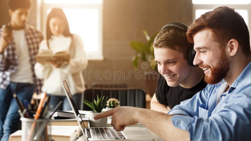 University Students at Library Studying Together and Connecting Online ...