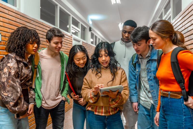 University Students Sharing Ideas and Using Tablet in School Hallway ...
