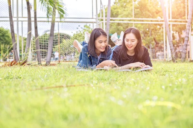 University Students Sit and Read on the Grass Stock Image - Image of ...