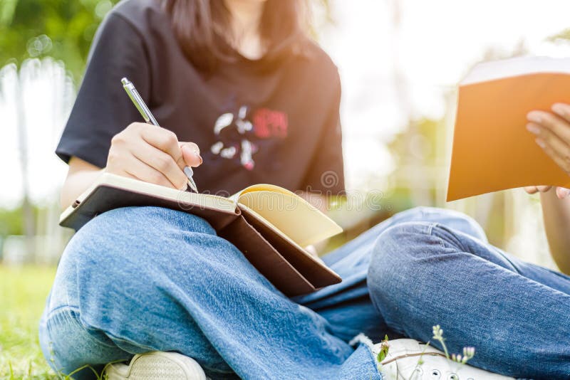 University Students Sit and Writing a Book on the Grass Stock Image ...