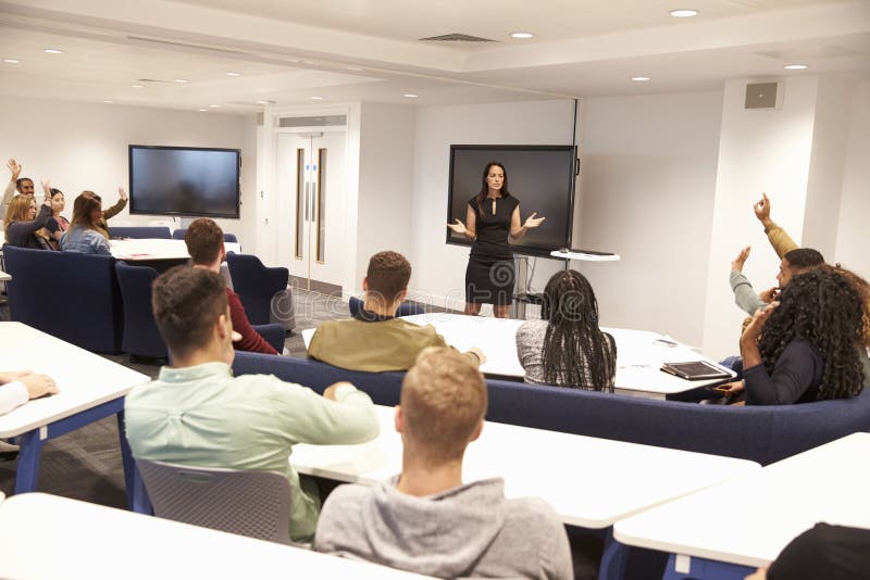 Female Teacher Addressing University Students in a Classroom Stock ...
