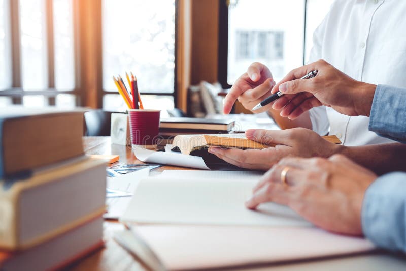 University Students Studying and Reading Together in Library Research ...