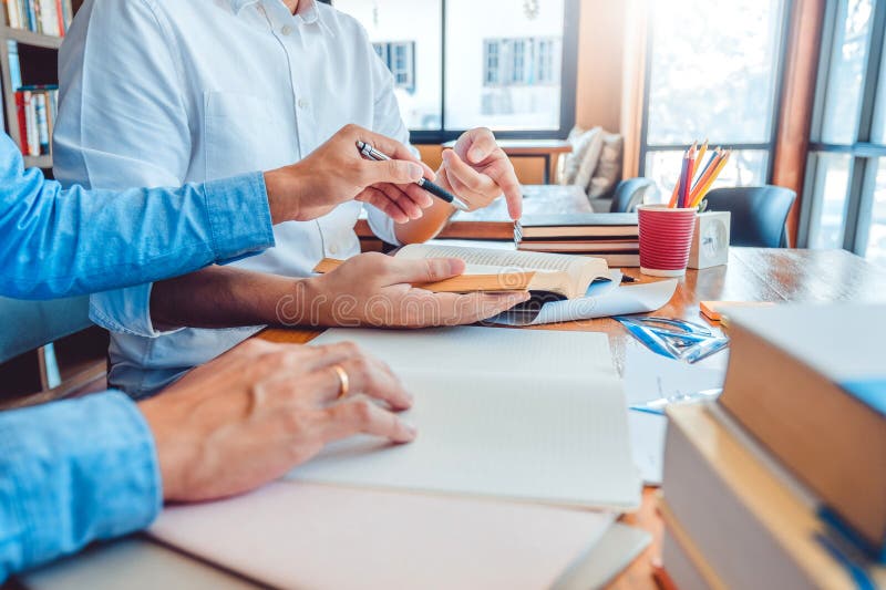 University Students Studying and Reading Together in Library Research ...