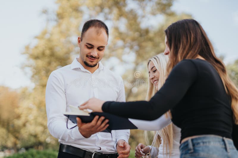 University Students Studying Subjects Together in a Park, Discussing ...