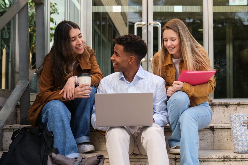 University Students Studying Together on Campus Steps Using Laptop and ...