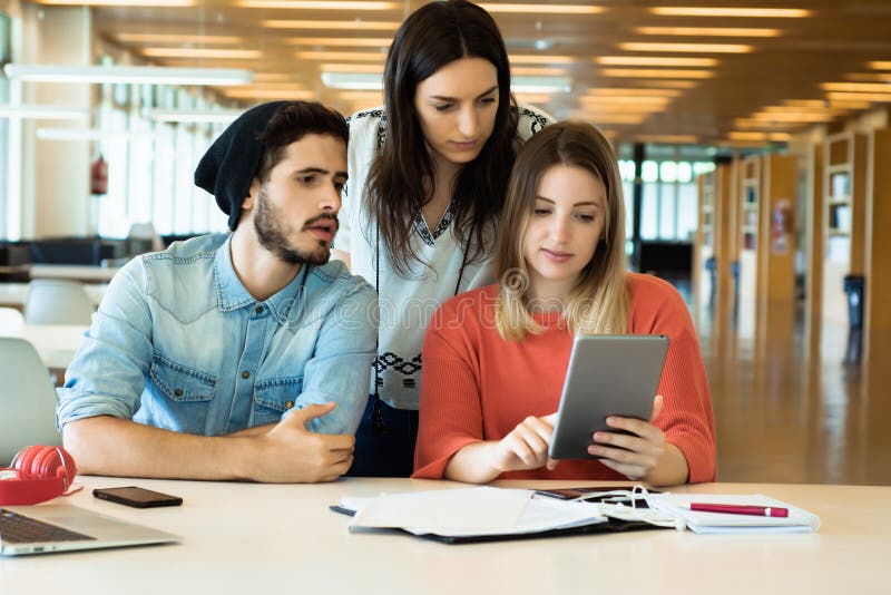 University Students Using Digital Tablet in University Library Stock ...