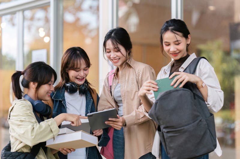University Students Using a Digital Tablet while Walking To Next Class ...