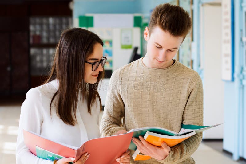 Hardworking Learners Working with Papers and Folders in College Stock ...