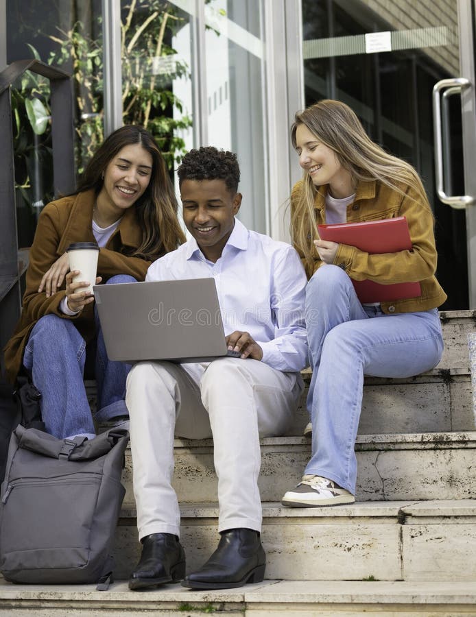 University Students Working on Project Outdoors with Laptop and Coffee ...