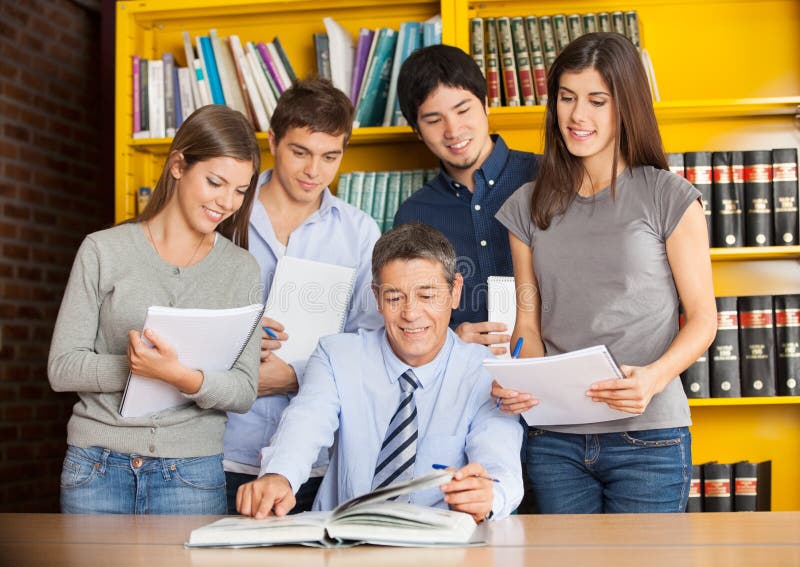 University Teacher with Books Explaining Students Stock Photo - Image ...
