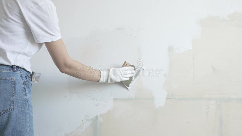 Unknown Female Construction Worker Applying Plaster with Putty Knife ...