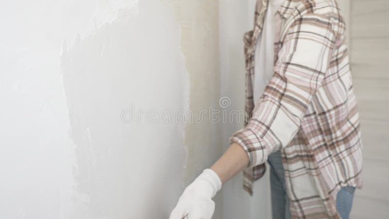 Unknown Female Construction Worker Applying Plaster with Putty Knife ...