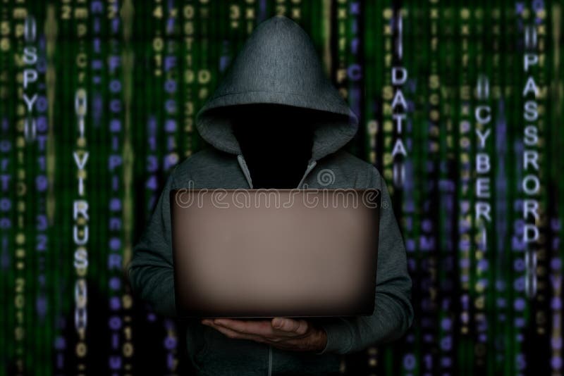 Unknown Hacker in the Hood with a Laptop in His Hand on a Background of ...